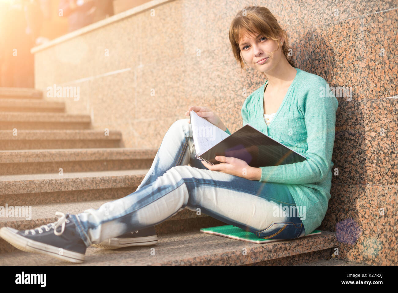 Girl sitting on stairs hi-res stock photography and images - Alamy