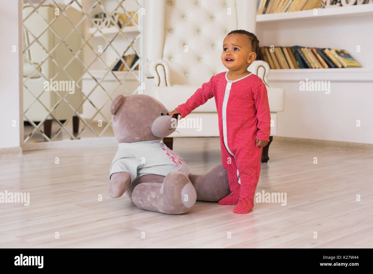 Happy baby boy playing with his teddy bear Stock Photo - Alamy