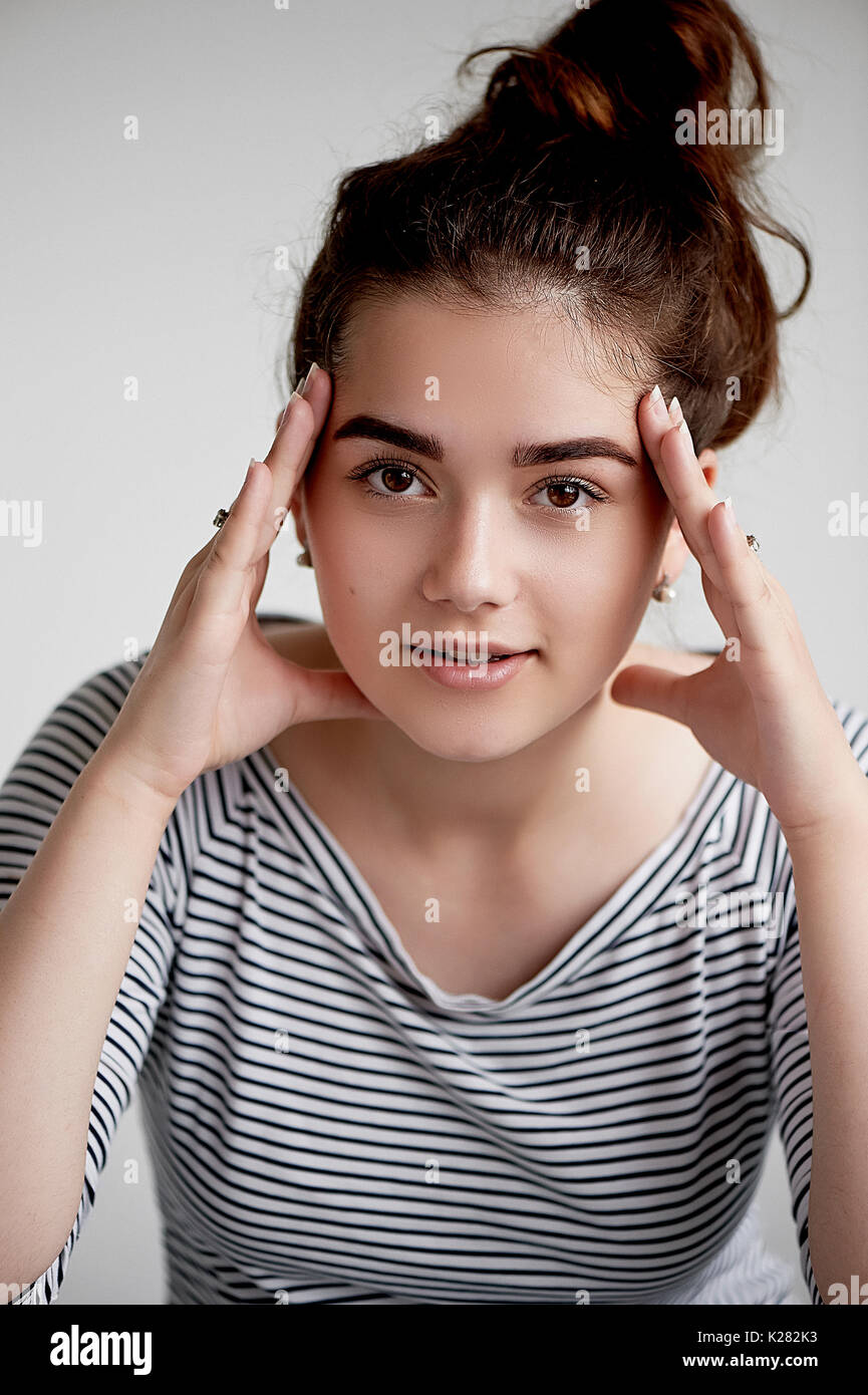a young girl looks open confident look.Two hands of a person. About ...
