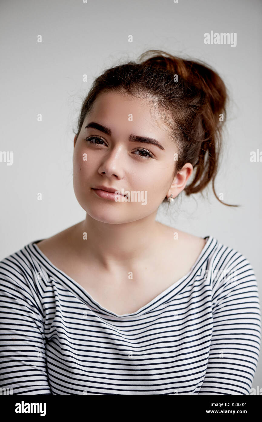 serious young woman thinking about something. a young girl looks open ...