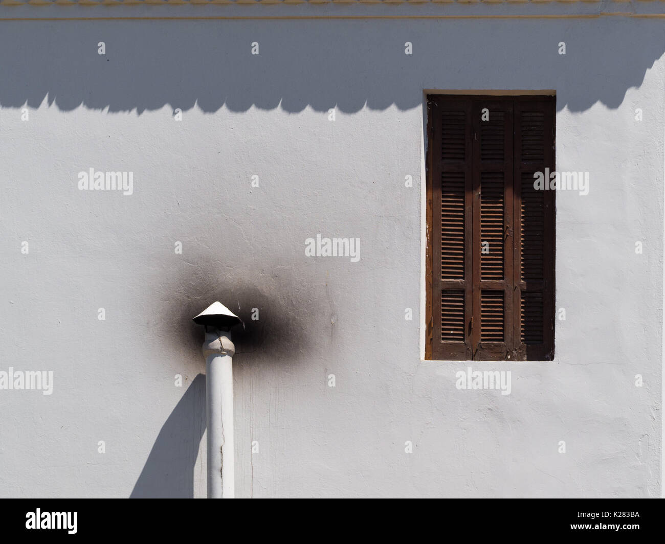 Brown window and chimney on a white wall Stock Photo - Alamy