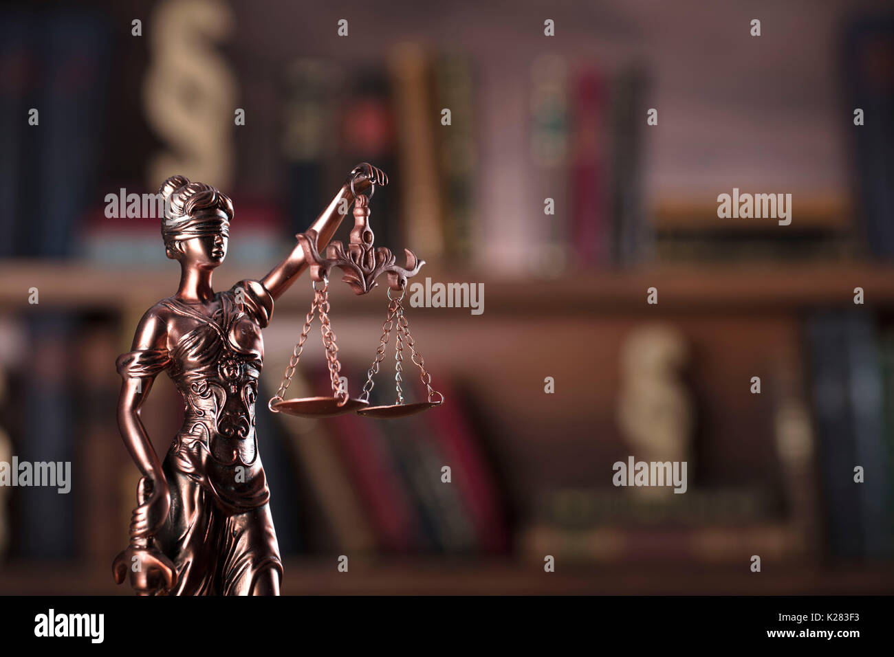 Law symbols. Statue of justice in the court library Stock Photo - Alamy