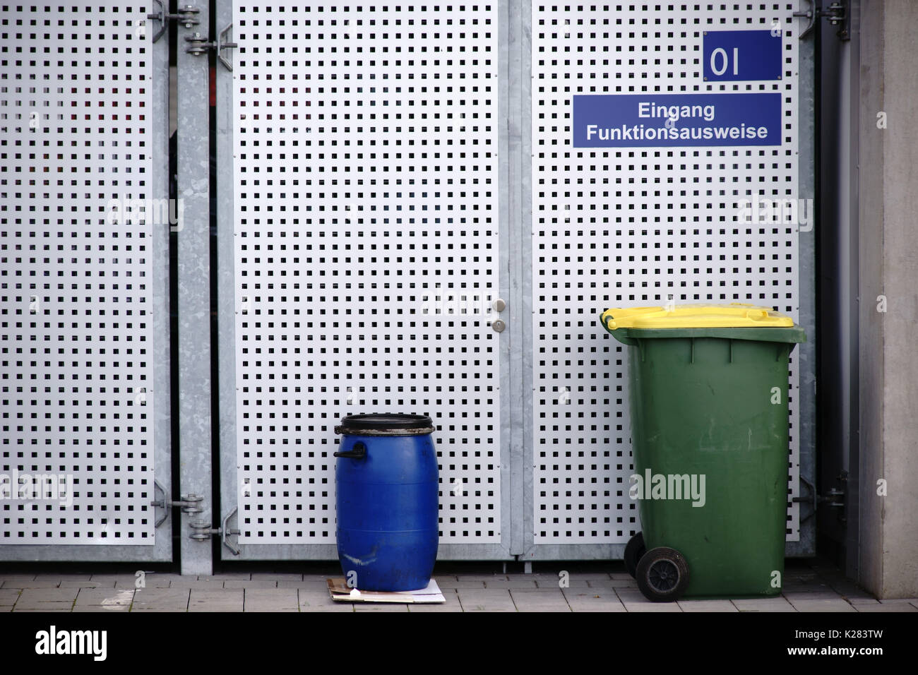 Waste containers are placed in front of a grid gate Stock Photo - Alamy