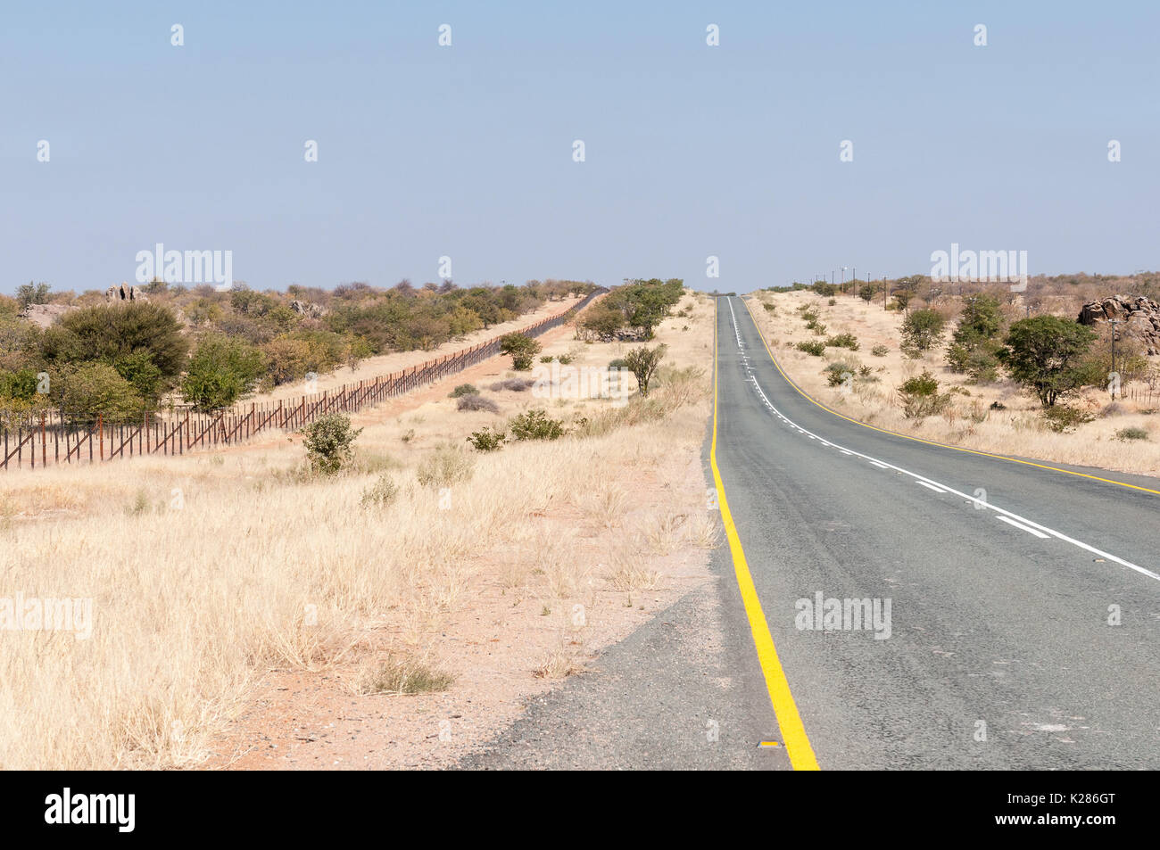The C35-road north of Kamanjab in North-Western Namibia. The fence of ...