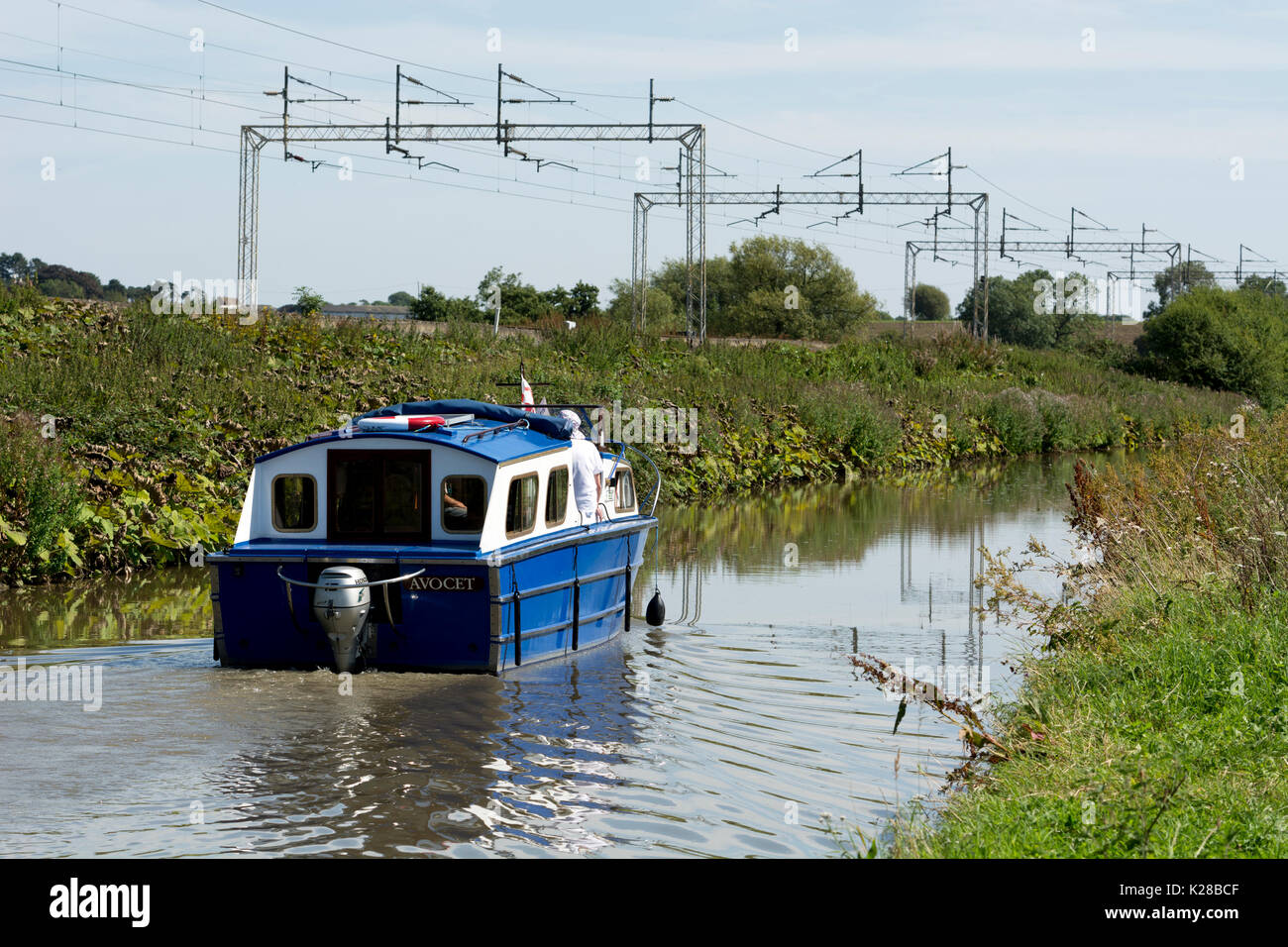 Cabin cruiser on the Oxford Canal alongside the West Coast Main Line ...