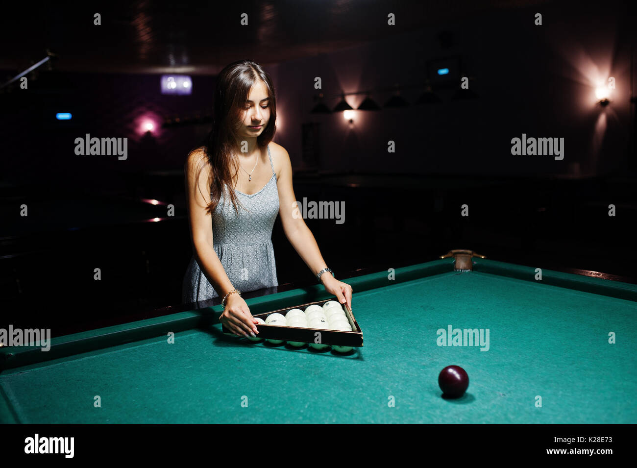 Portrait of a stunning woman standing next to the billiards table Stock ...