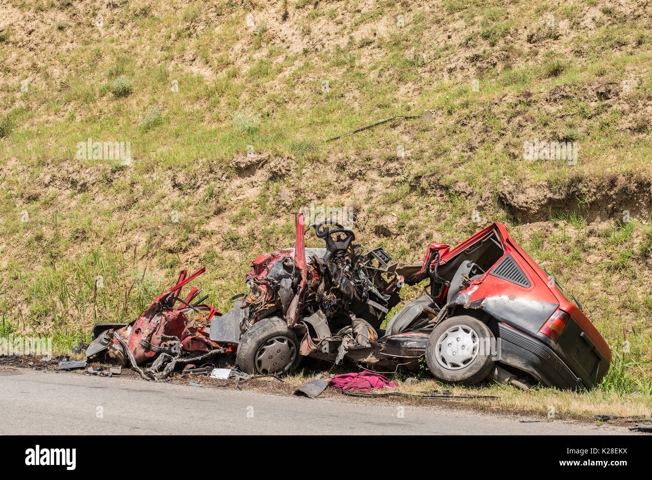 Unrecognizable car wreck beside a road Stock Photo - Alamy