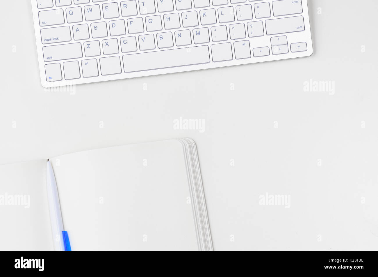White workplace with keyboard and notebook, view from above Stock Photo ...