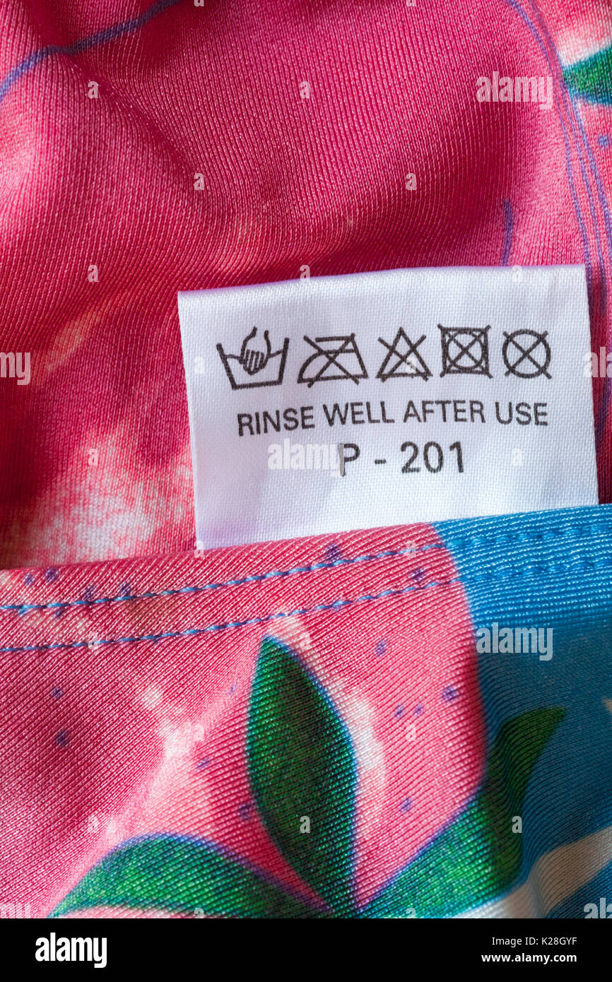Rinse well after use label in bikini showing washing care symbols Stock ...