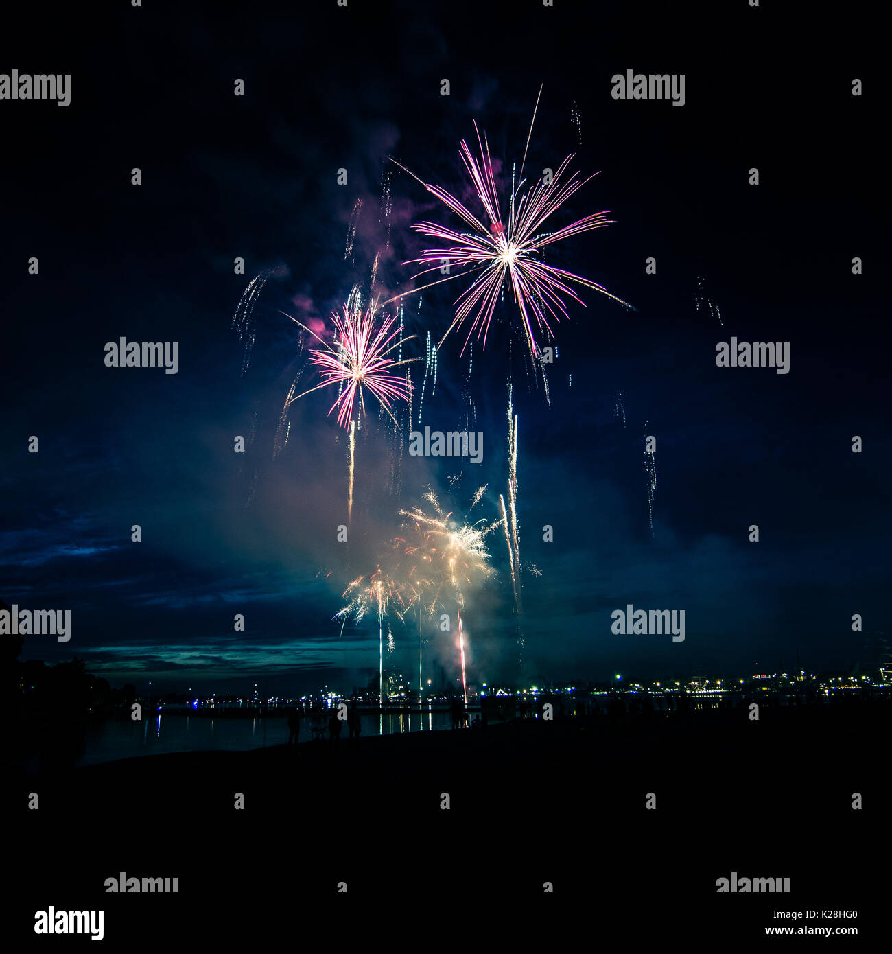 Beautiful, colorful fireworks above the river during an Independence ...