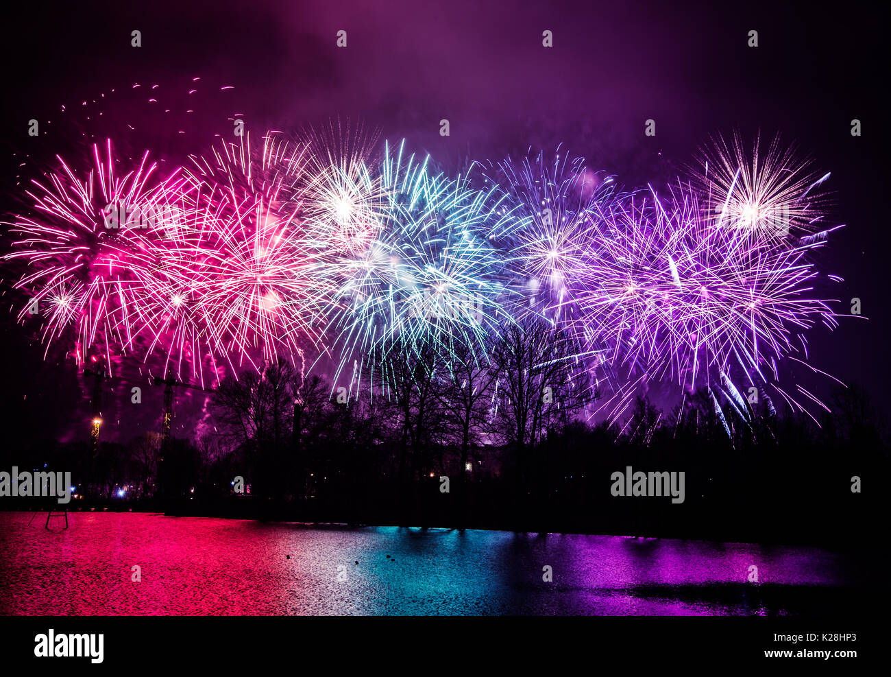 Beautiful, colorful fireworks above the river during an Independence ...