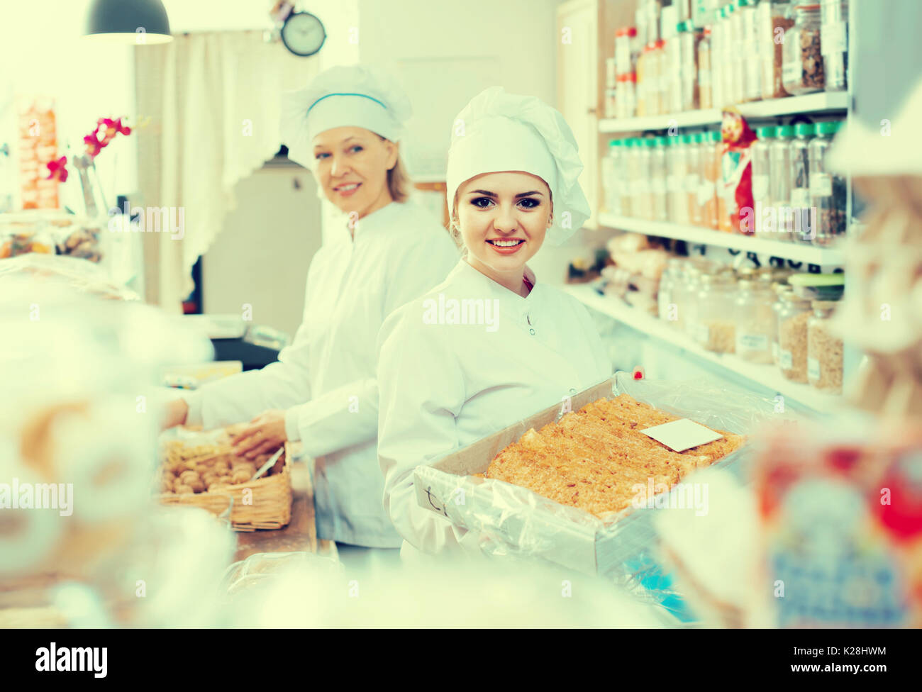 young russian women with hats selling nuts and pastry in shop Stock ...