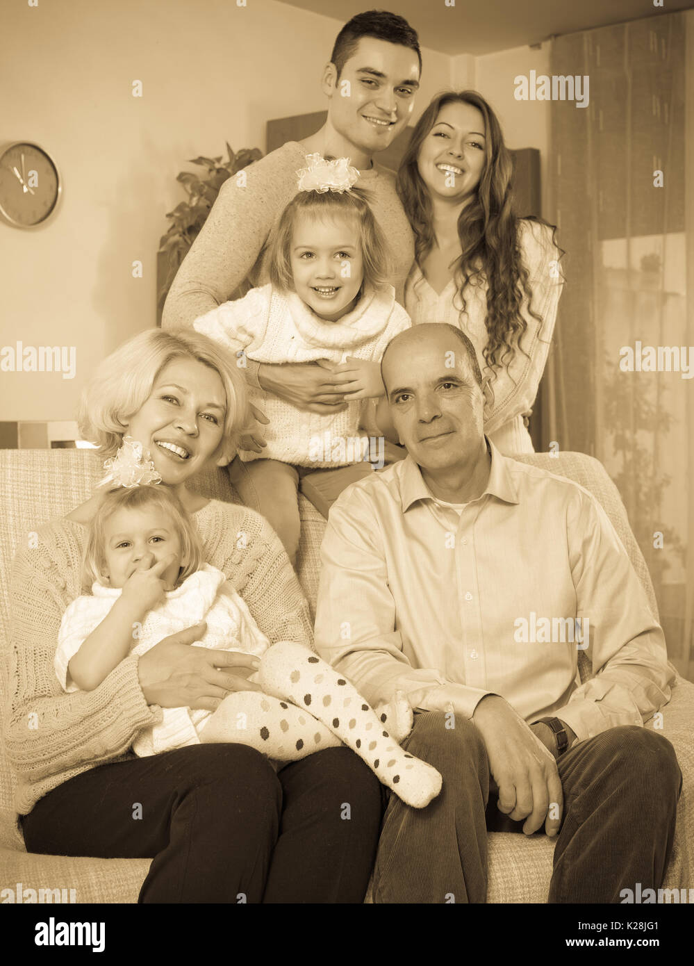 Happy united family members laughing together in living room Stock ...