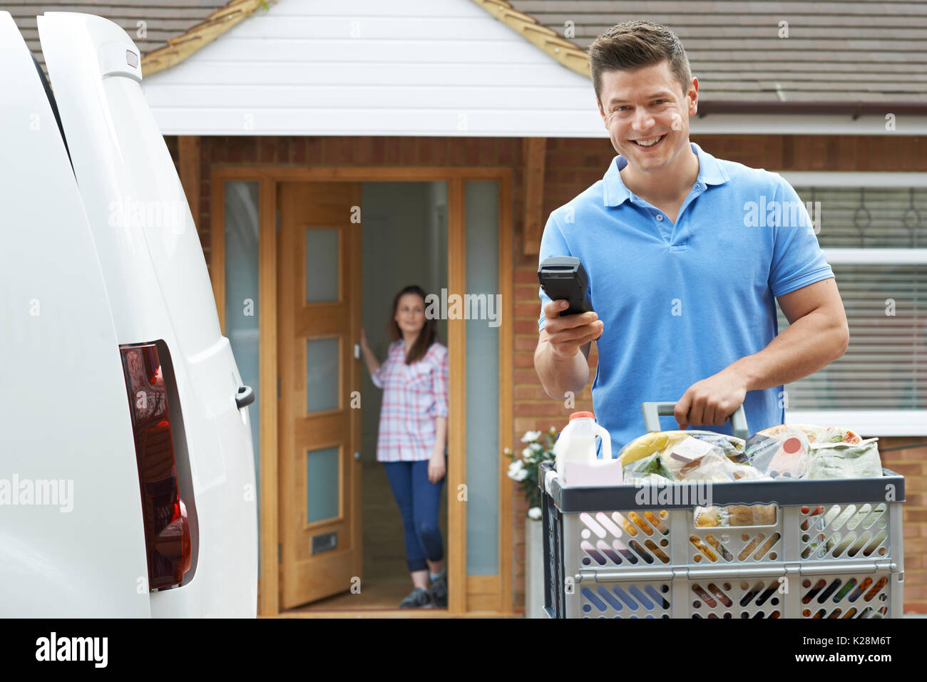 Women delivering groceries to man hi-res stock photography and images ...