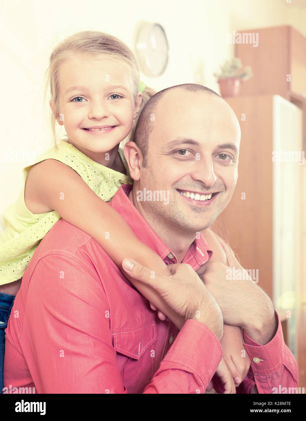 Happy european father and little daughter posing in domestic interior ...