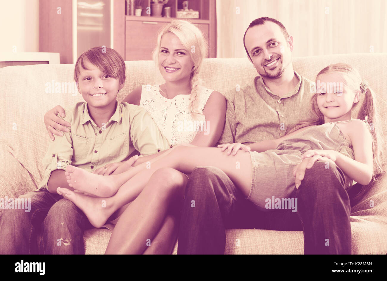 happy russian parents with two children posing in home interior Stock ...