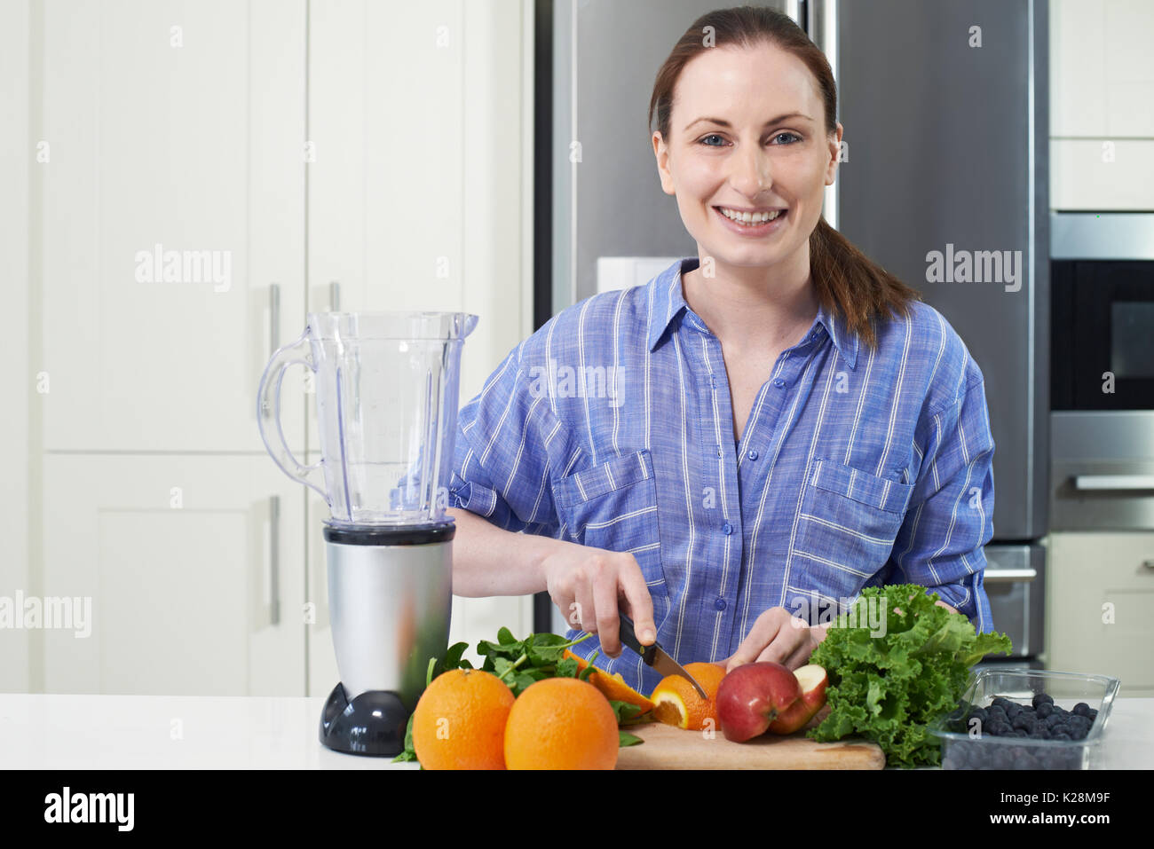 Woman chopping fruit hi-res stock photography and images - Alamy