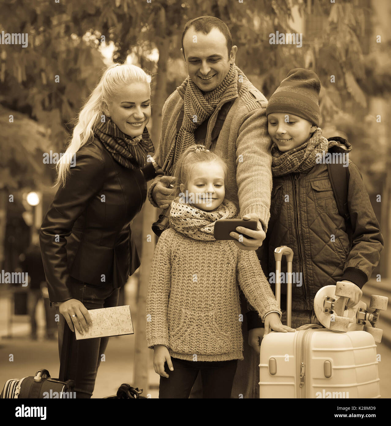 Traveling spanish spouses with children shooting mutual portrait on ...