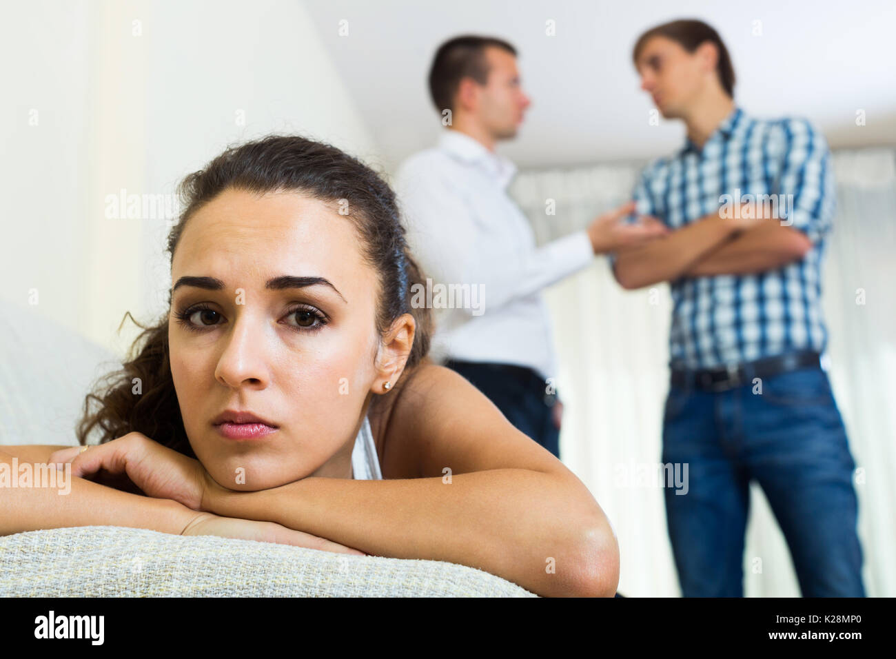 Sad american girl having argue with her friends at home. focus on girl ...