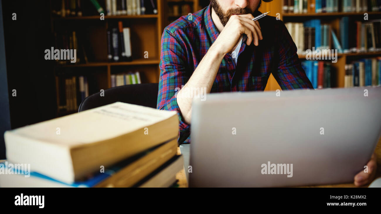 Student studying in library at university Stock Photo - Alamy