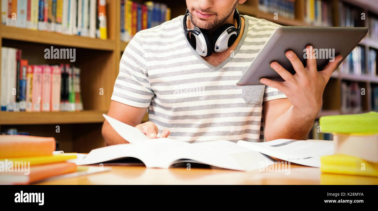 Student studying in library with tablet Stock Photo - Alamy