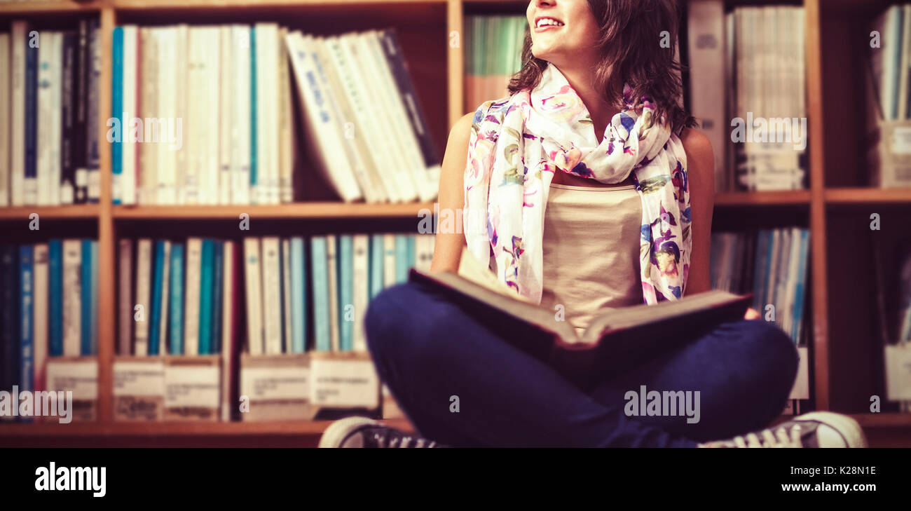 Beautiful young female student sitting on floor hi-res stock ...