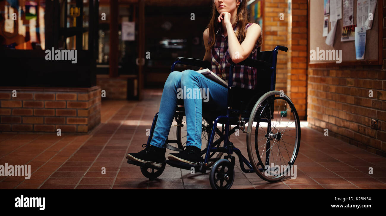 Disabled schoolgirl on wheelchair in corridor at school Stock Photo - Alamy