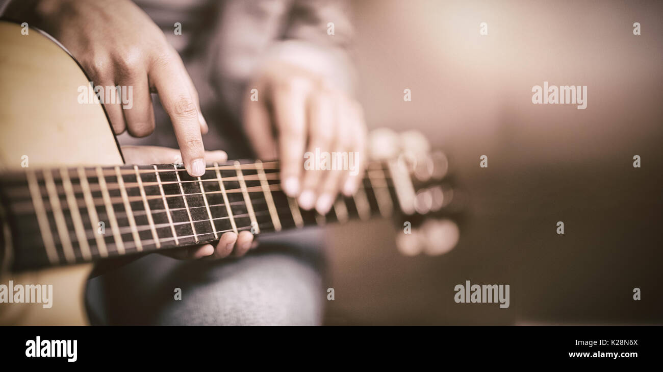 Teacher giving guitar lessons to pupil Stock Photo - Alamy