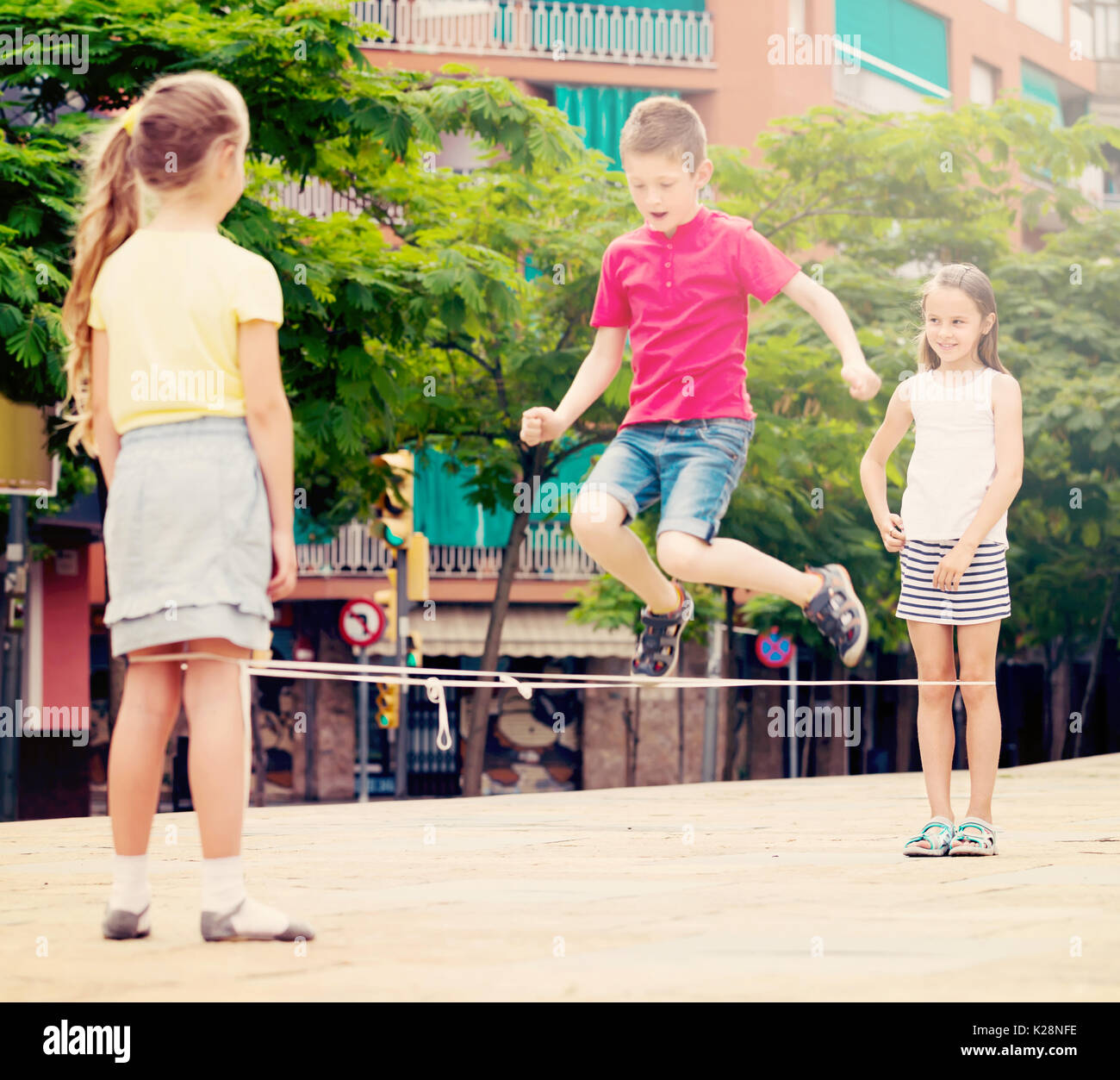 cheerful boy and girls in elementary school age playing with chinese ...