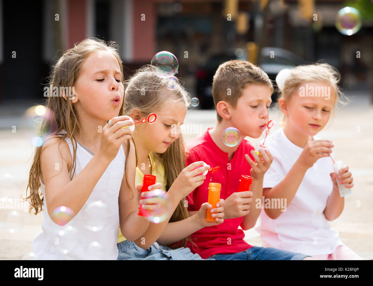 Group kids blowing soap bubbles hi-res stock photography and images - Alamy