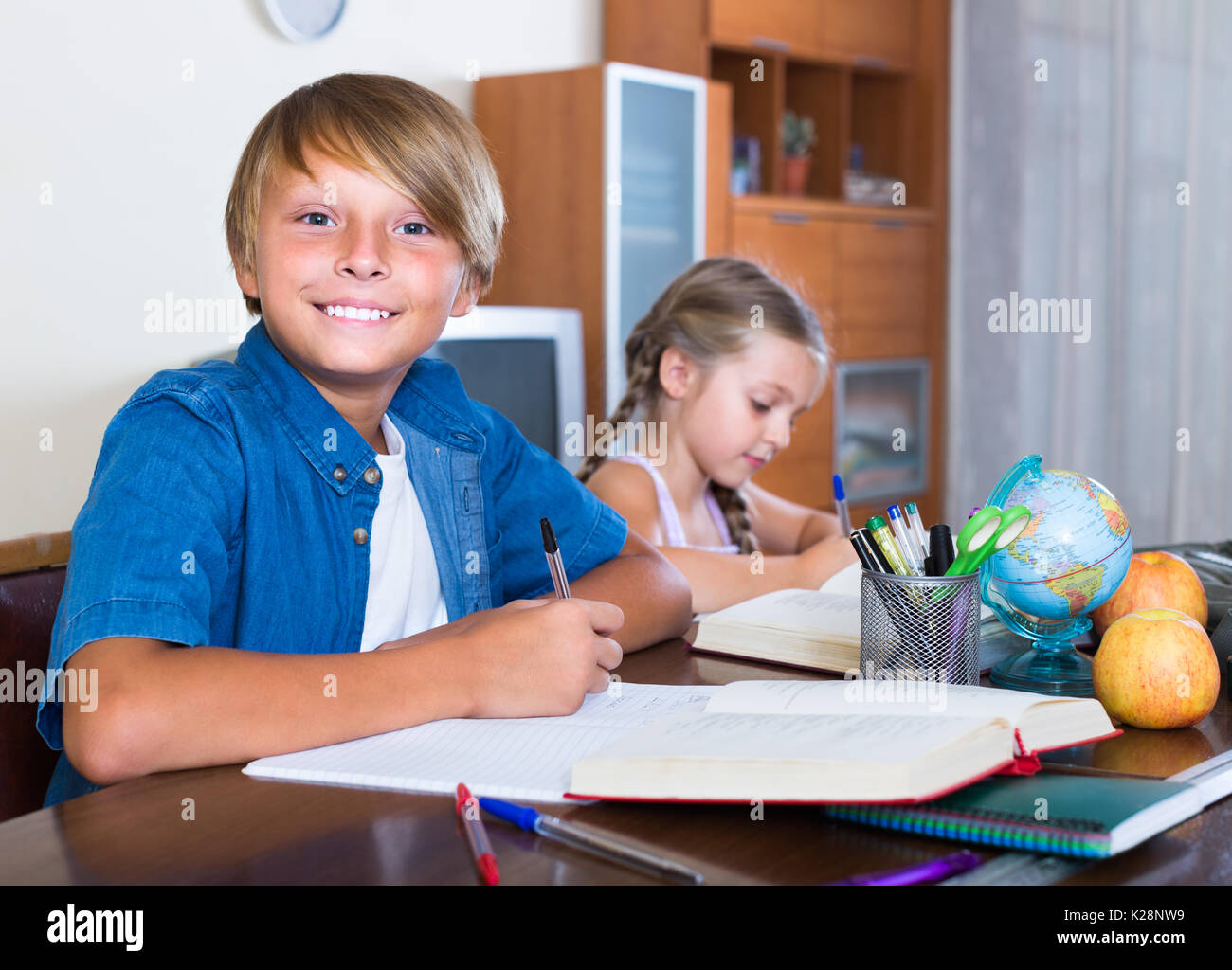 Teen brother reading books to young hi-res stock photography and images ...
