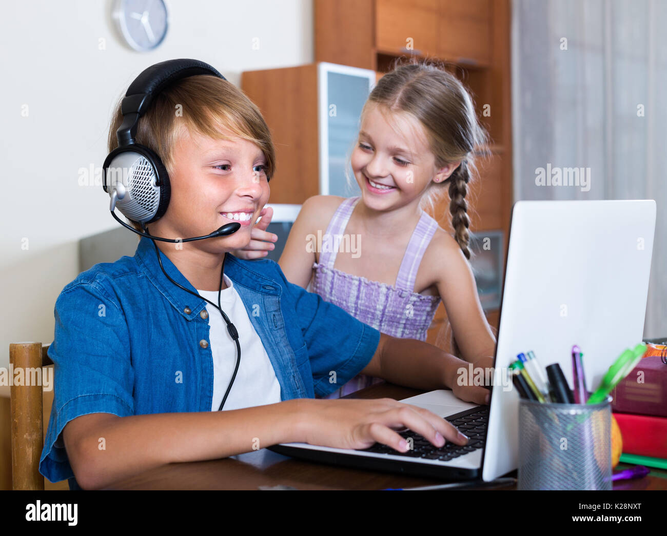 Kids smiling and playing online game on laptop indoors Stock Photo - Alamy