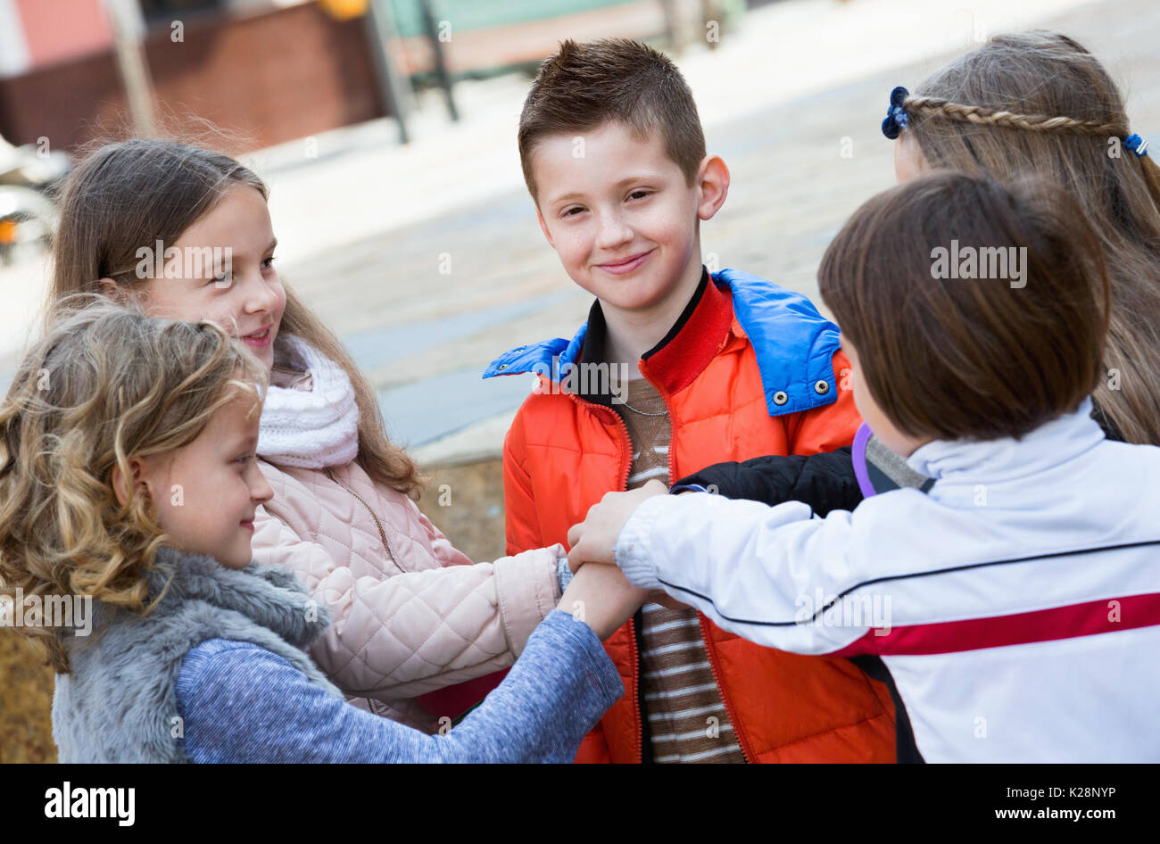 Positive happy smiling children holding hands and giving friendship vow ...