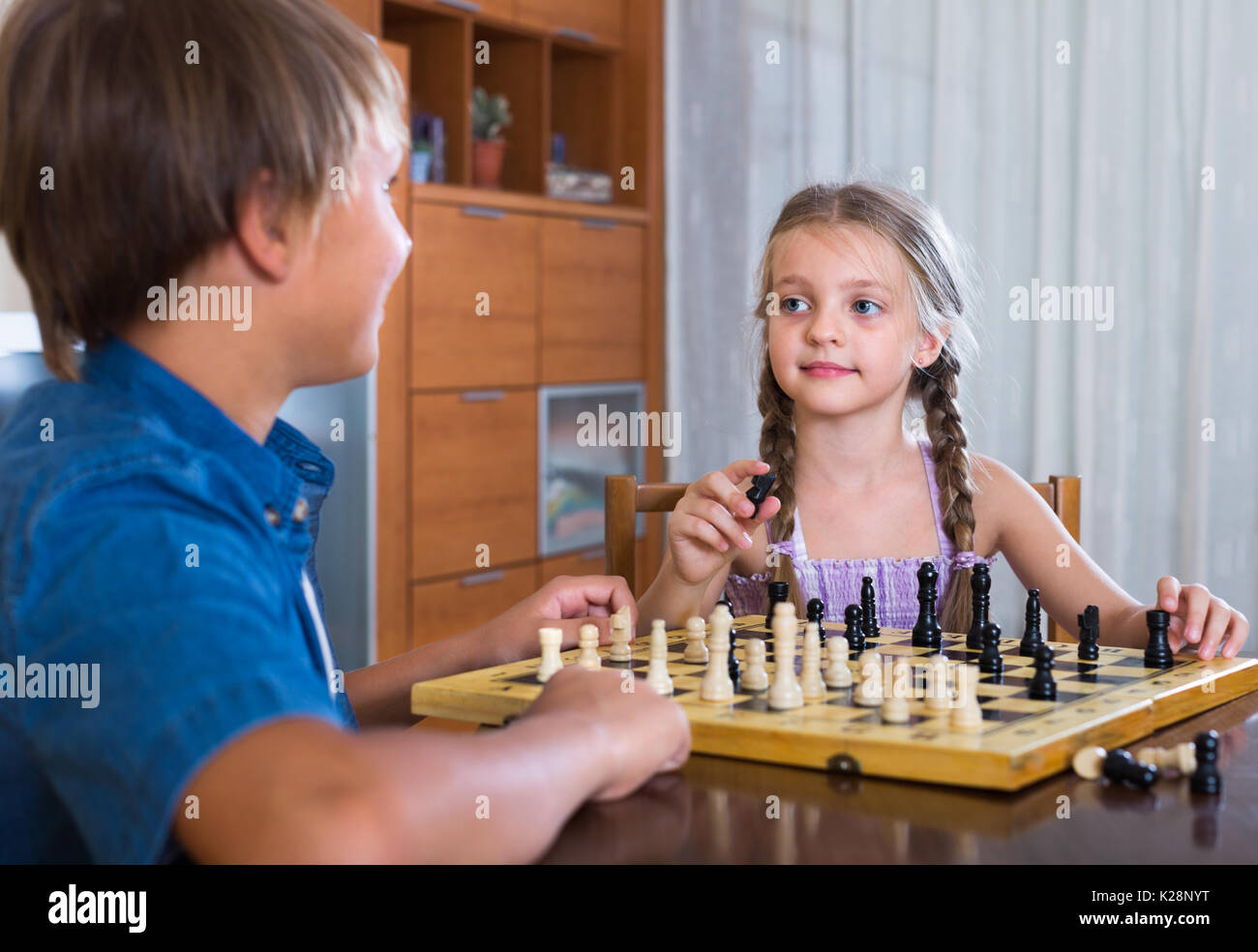 Portrait of successful children at chess board indoors Stock Photo - Alamy