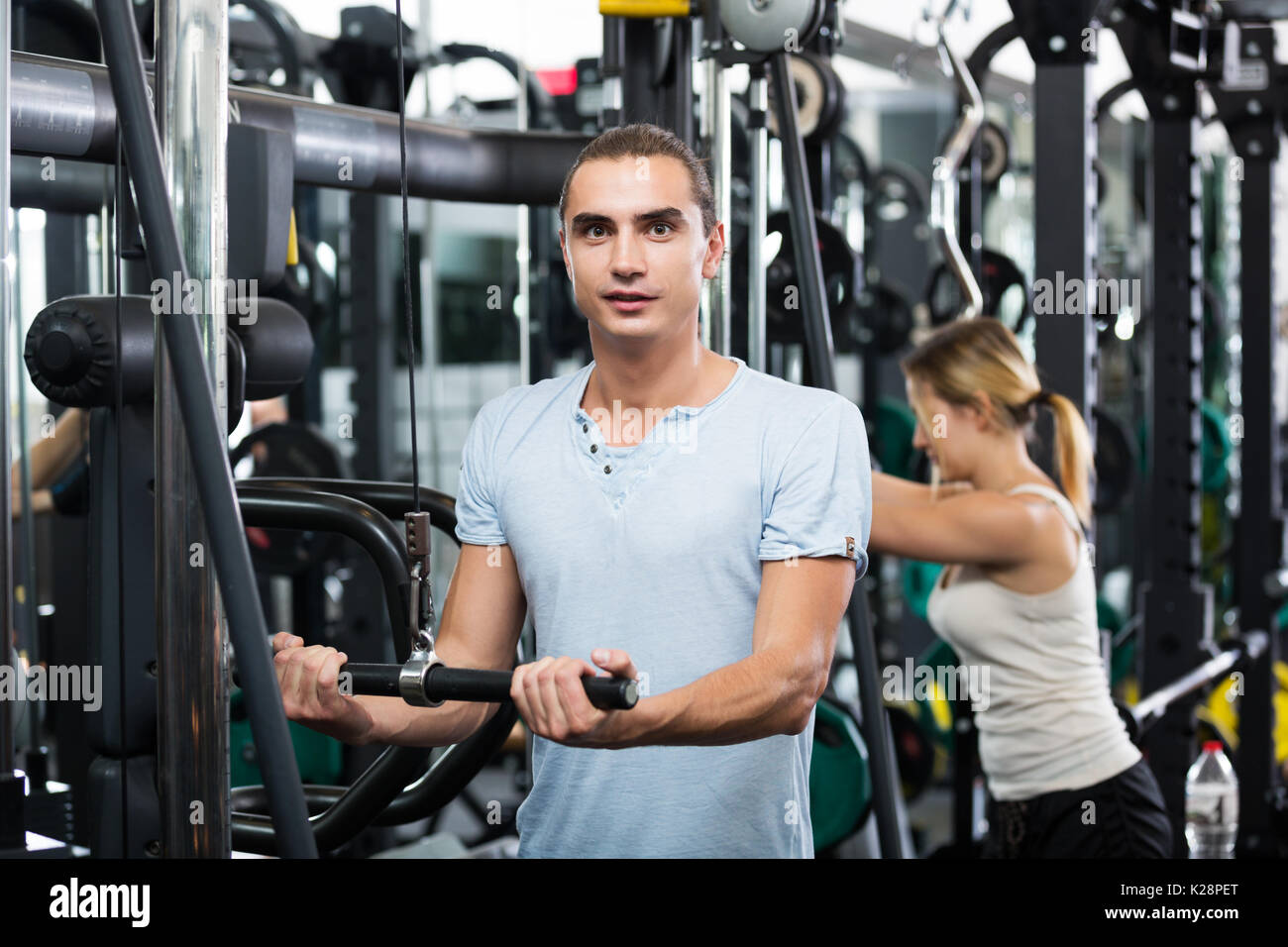 Positive active people having strength training under coach control in ...