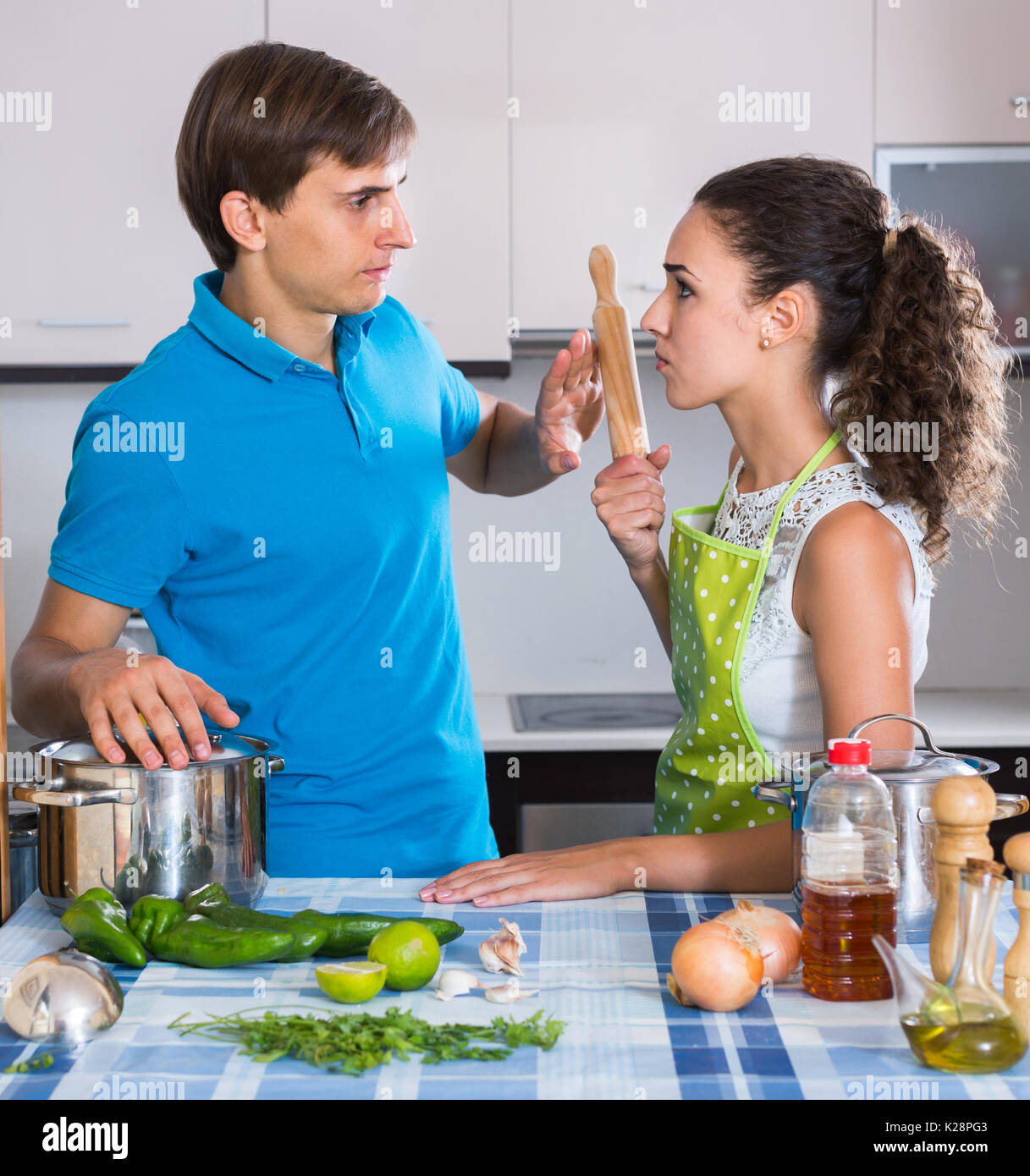 Young american family couple with serious faces quarrelling in kitchen ...