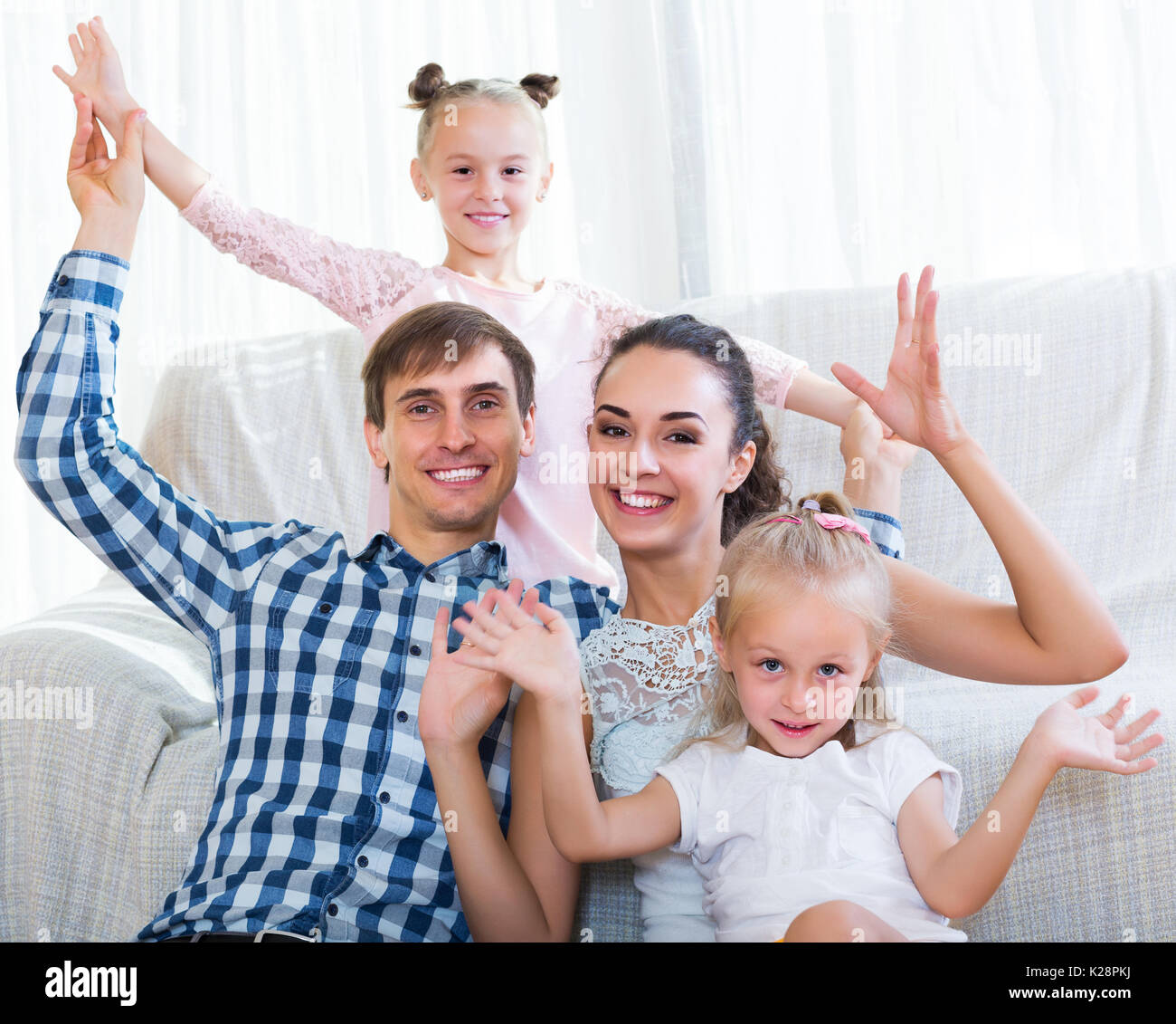 Relaxed family four posing hi-res stock photography and images - Alamy
