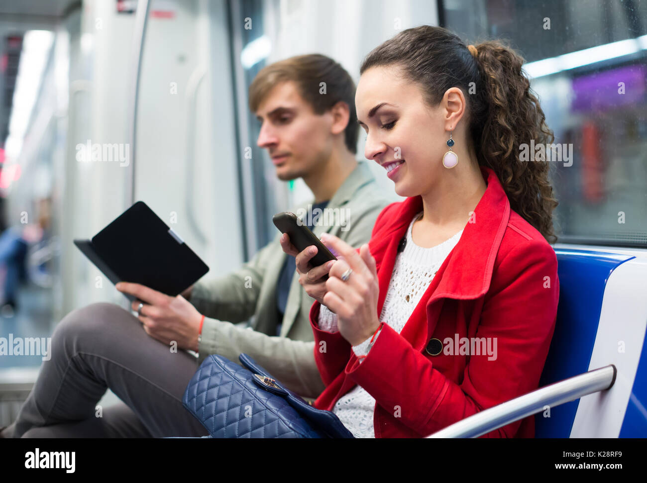 Ordinary passengers reading with ebook and mobile phone underground ...