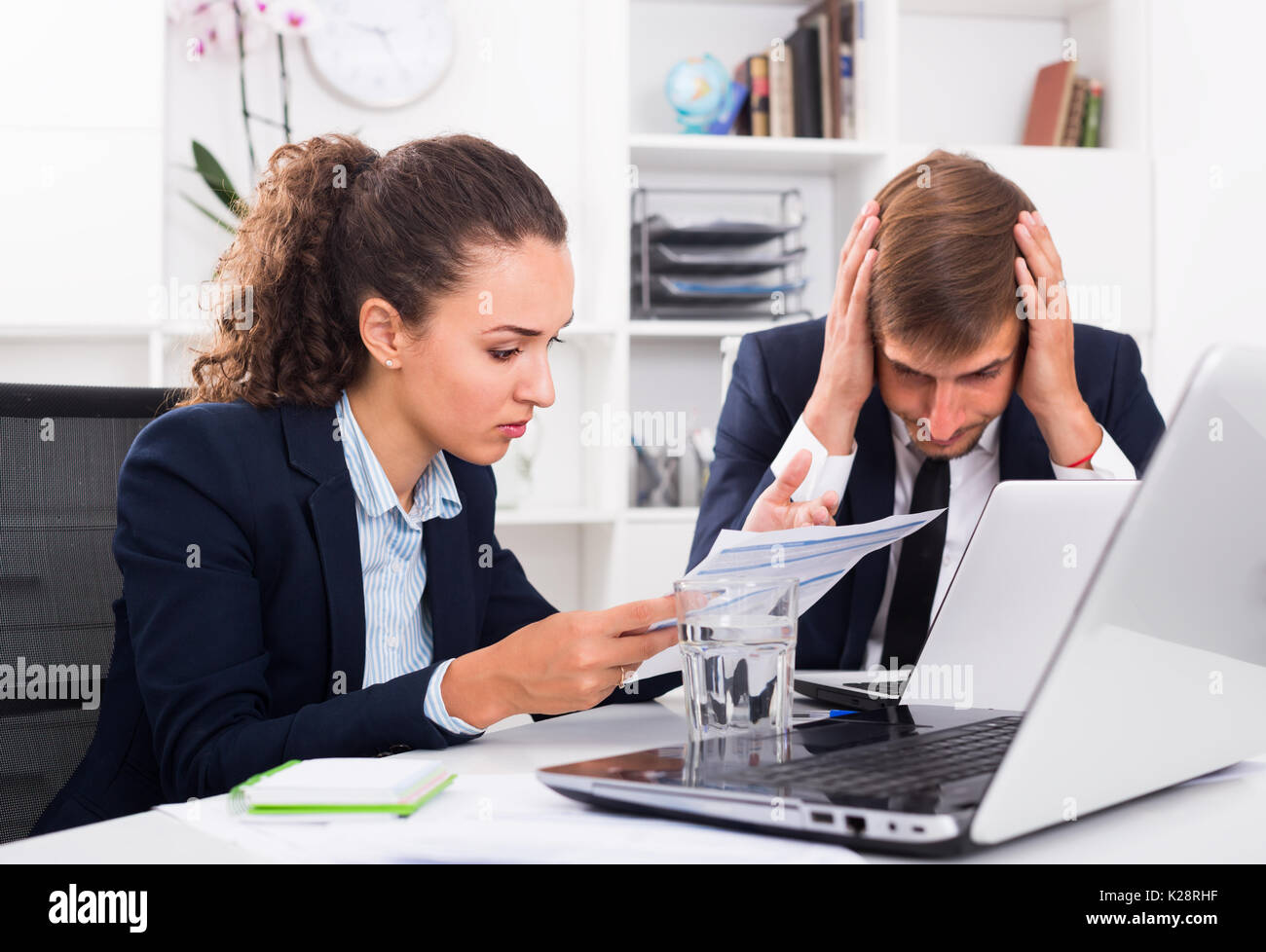 sad man and woman coworkers experiencing business failure in firm ...
