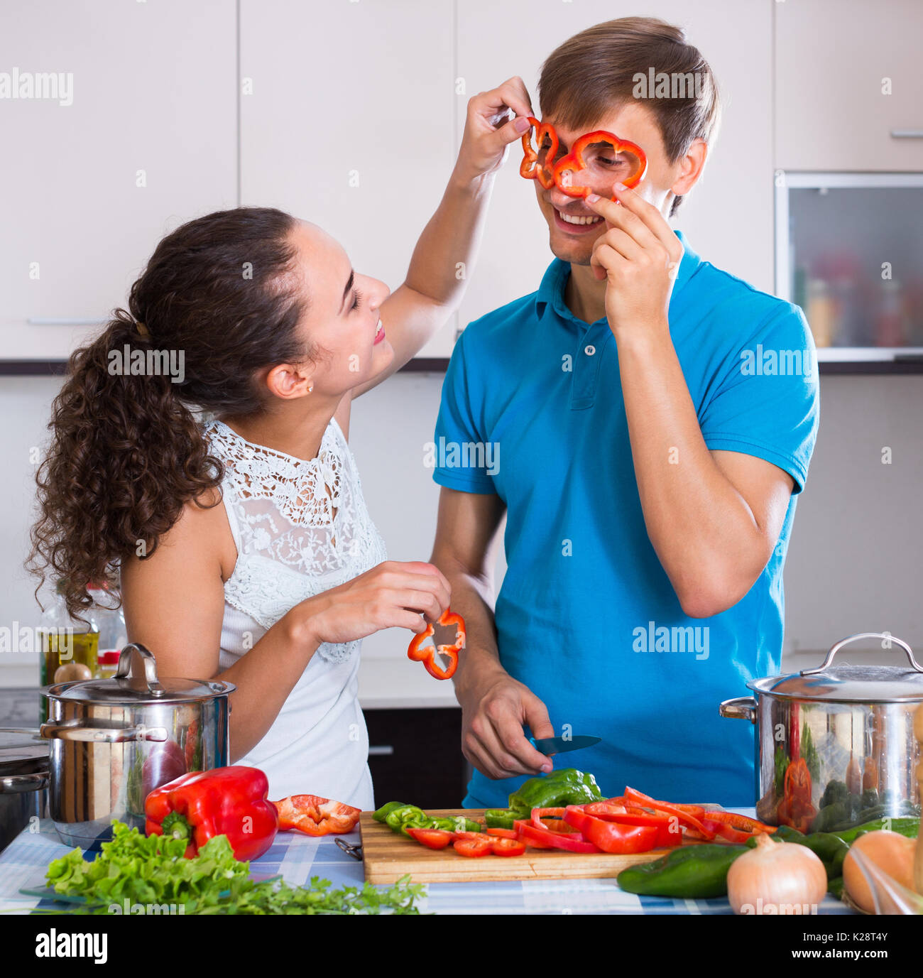Young family couple cooking vegetables in domestic interior Stock Photo ...