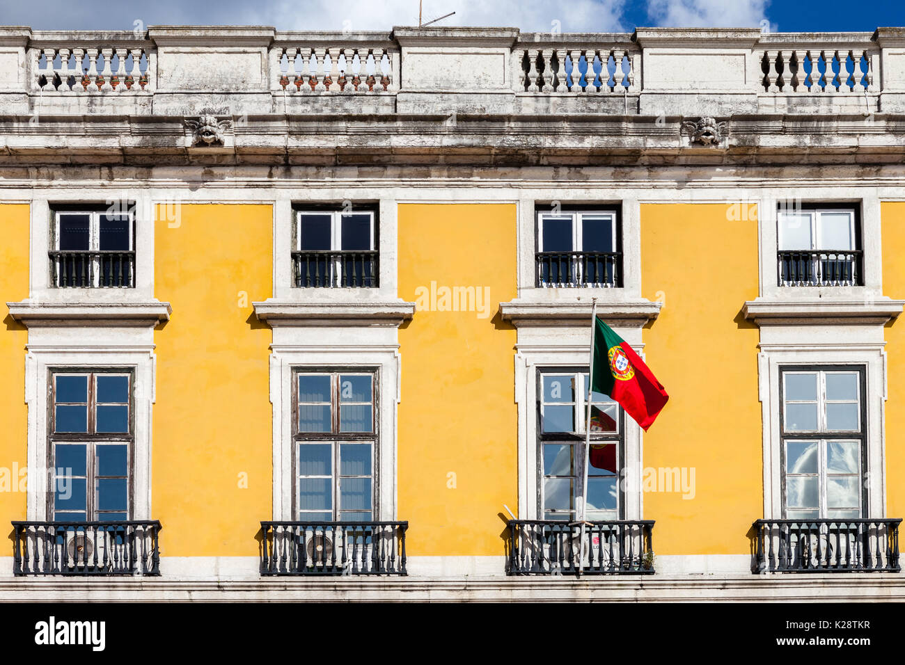 Yellow building with Portugal flag Stock Photo - Alamy