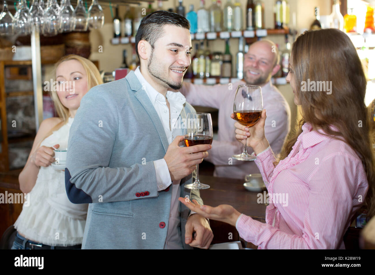 Restaurant cheerful visitors waiting for table and drinking wine at ...
