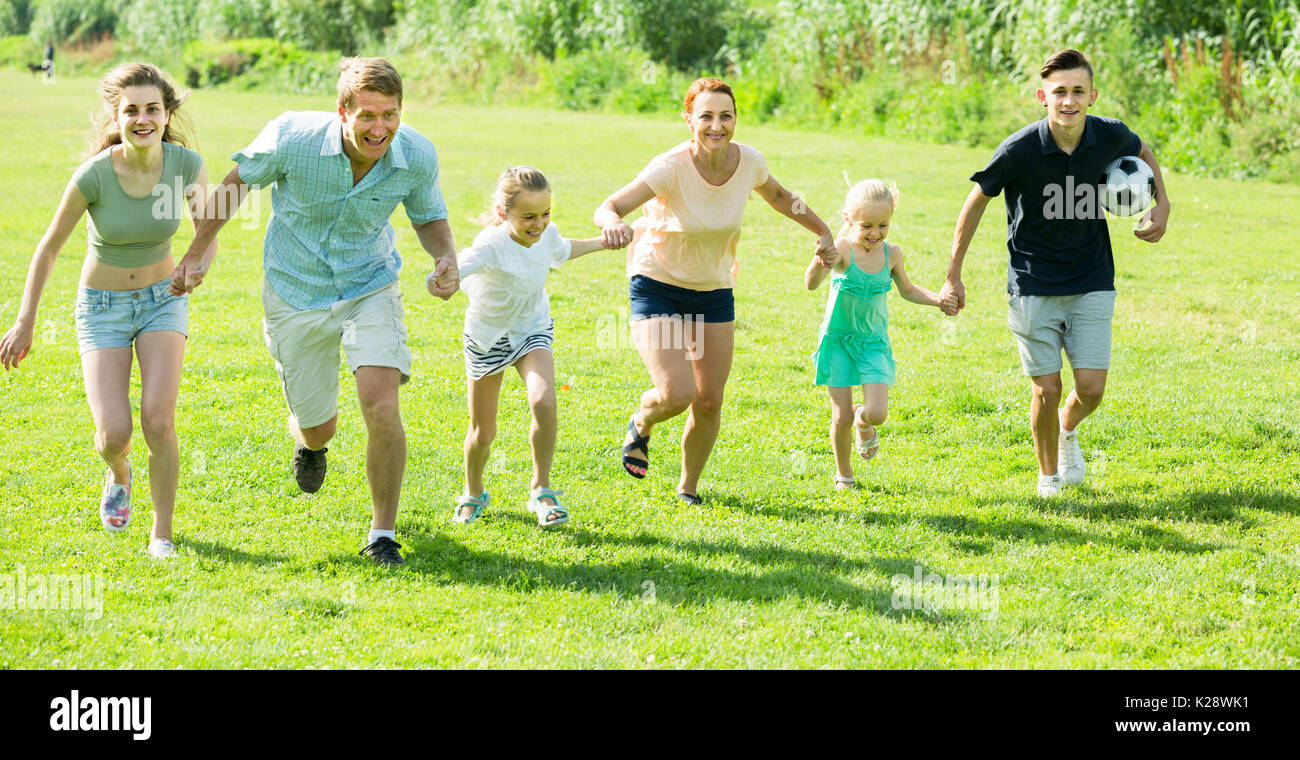 Family kids happily running hi-res stock photography and images - Alamy