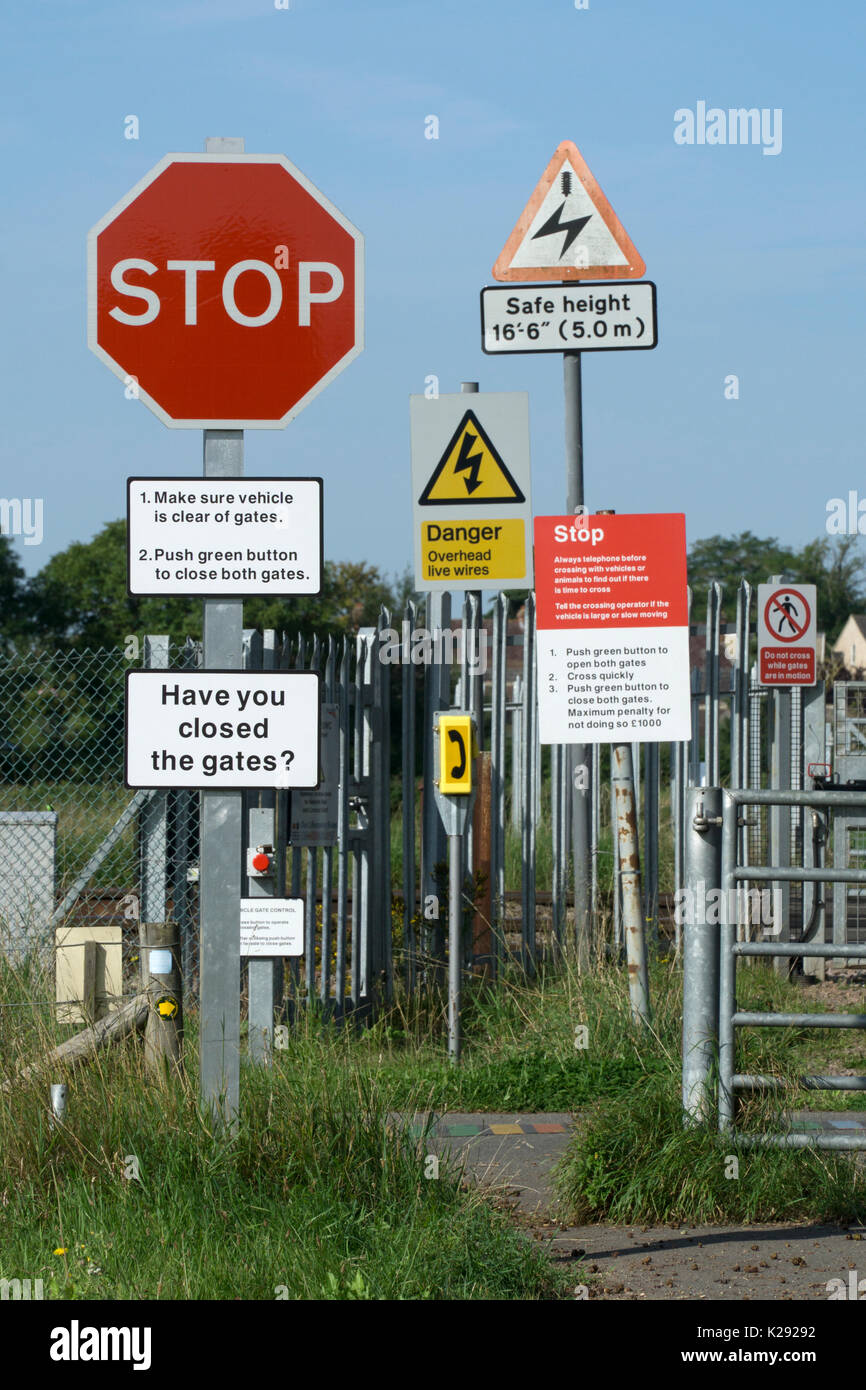 multiple signs at level crossing Stock Photo - Alamy