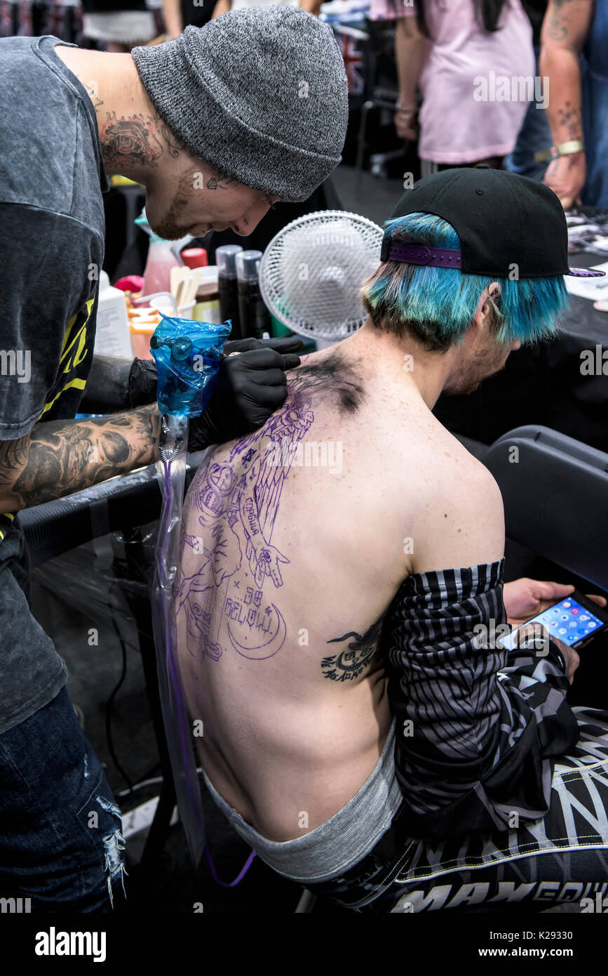 Tattooing customer hi-res stock photography and images - Alamy