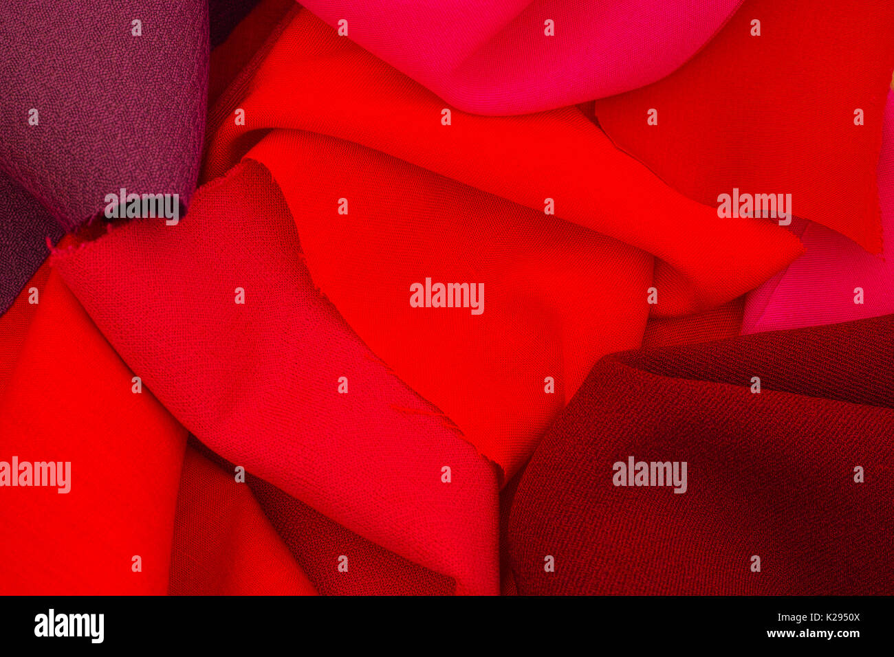 Pieces of red textile. Full frame Stock Photo - Alamy