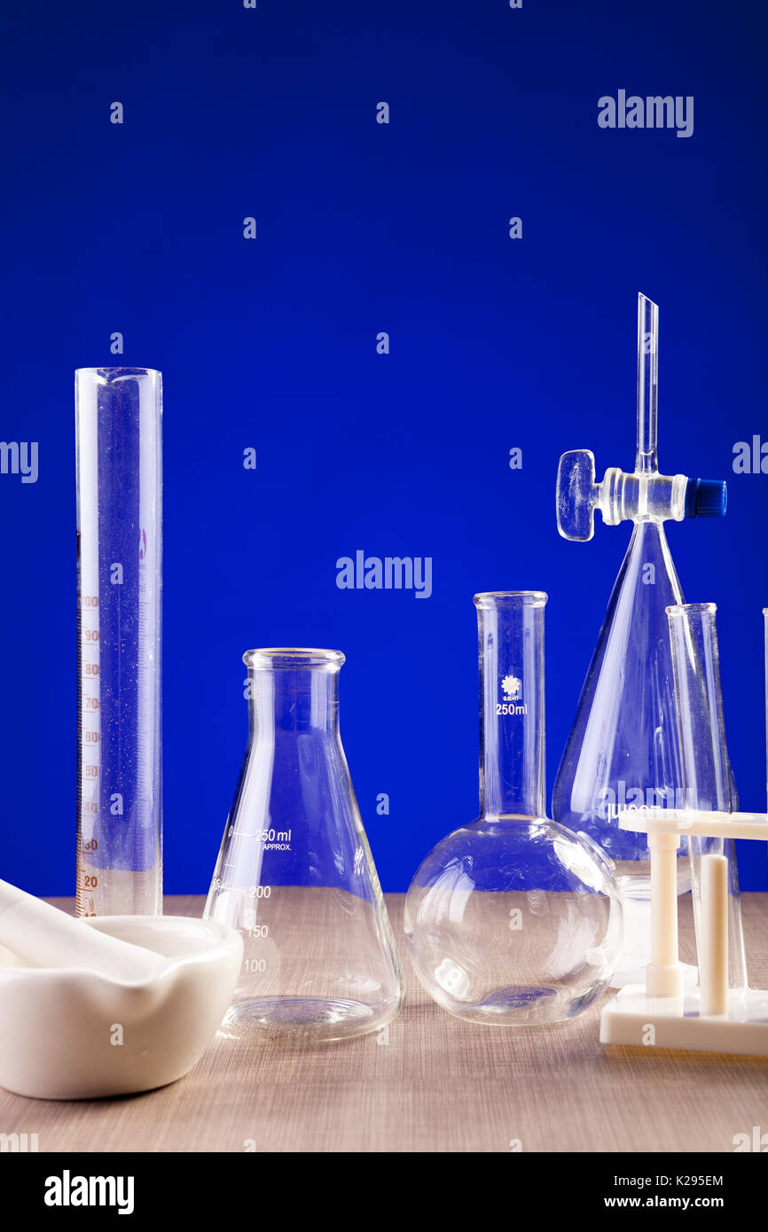Chemistry lab set on table over blue background Stock Photo - Alamy