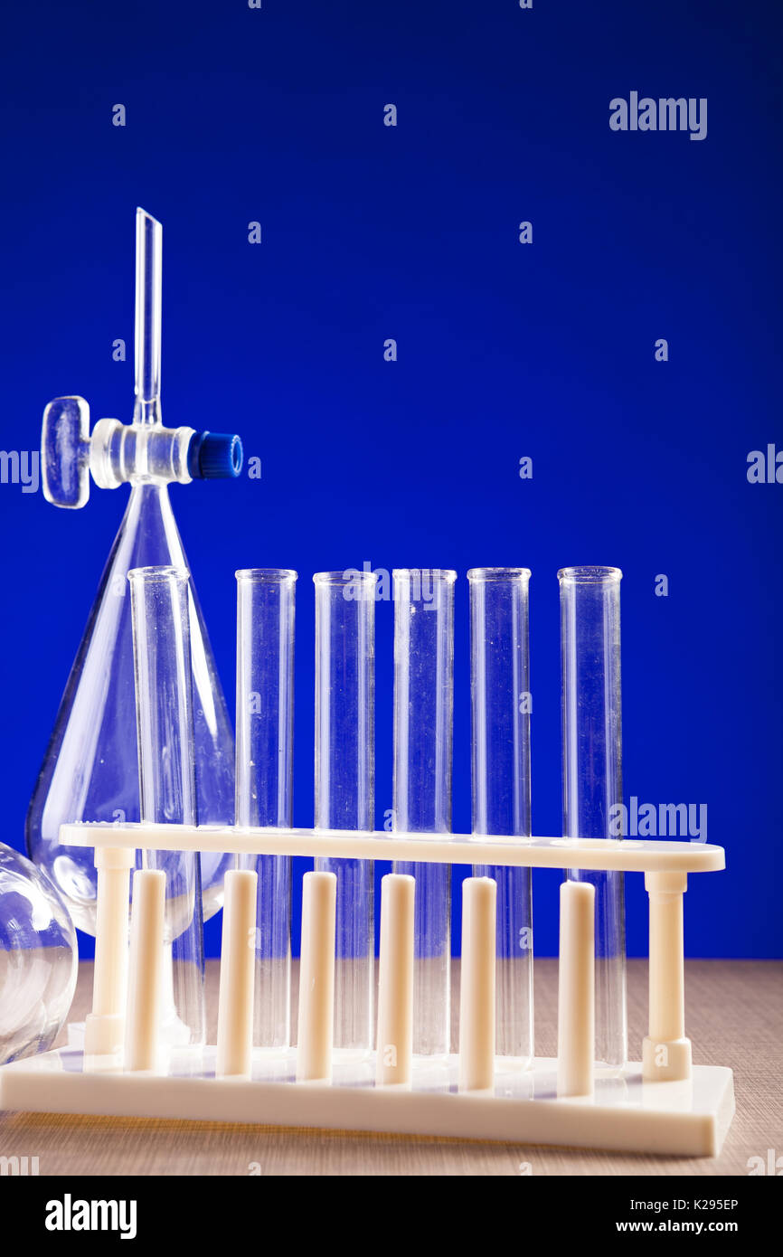 Chemistry lab set on table over blue background Stock Photo - Alamy