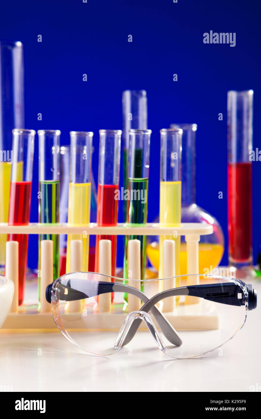 Chemistry lab equipment set on a table over blue background Stock Photo ...