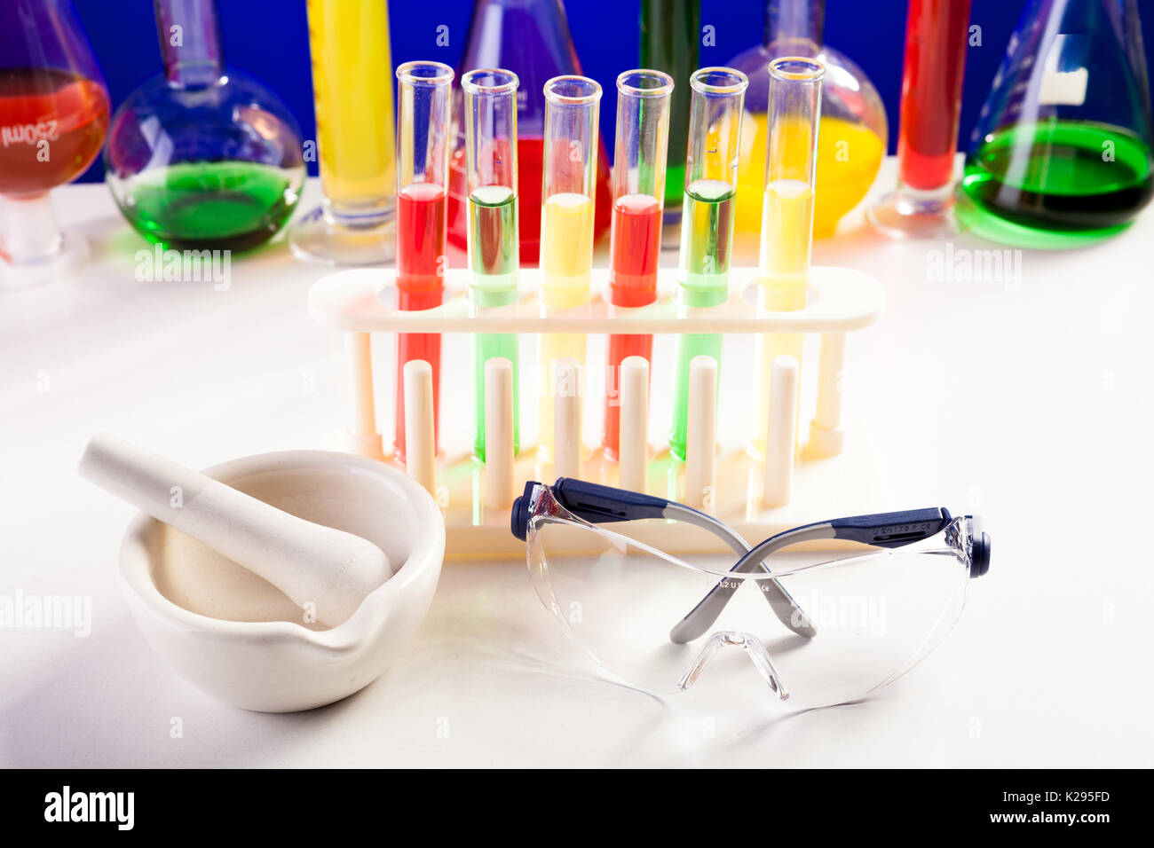 Chemistry lab equipment set on a table over blue background Stock Photo ...